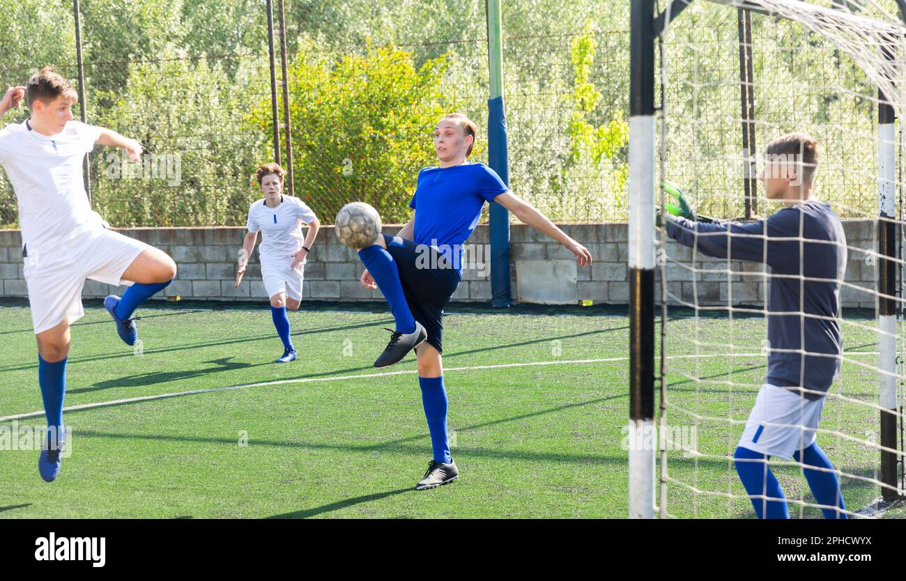 Teens playing soccer football match. Competition between two youth ...