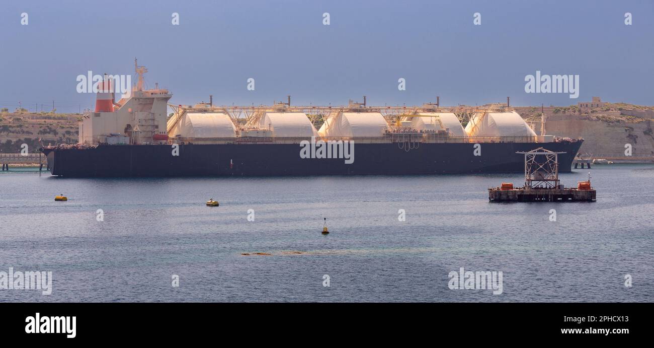 Huge tanker gas carrier at the berth of a power station on the island ...