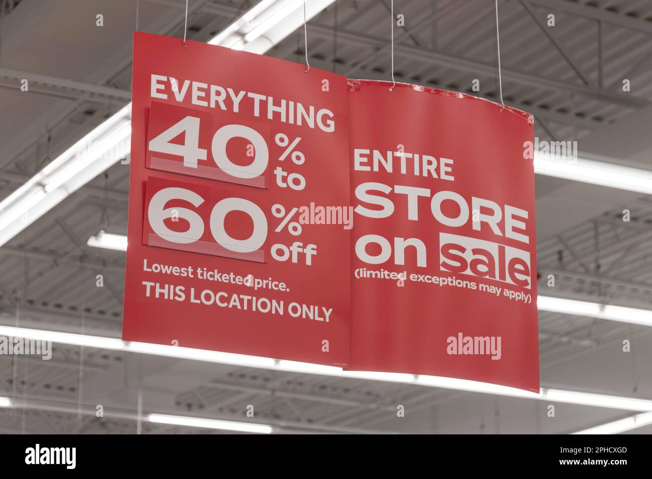 Store clearance and discount signs displayed at a soon to be out of ...