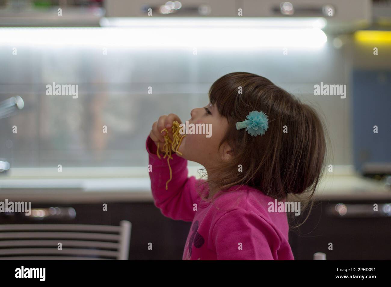 Little girl eating spaghetti happy hi-res stock photography and images ...