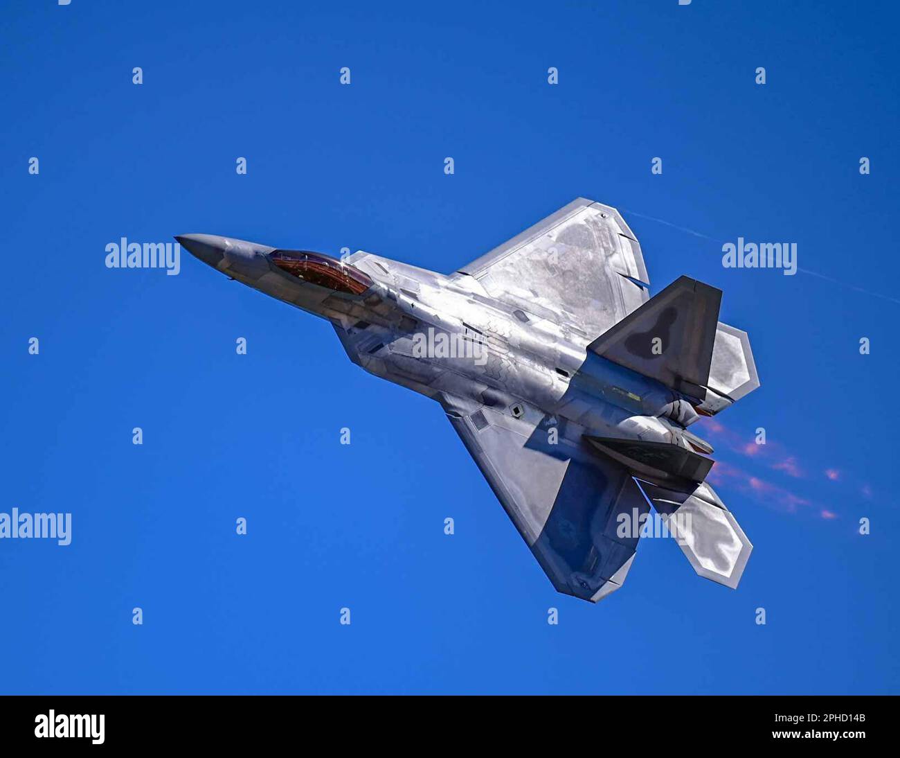 The U.S. Air Force F-22 Raptor Demo team performs aerial maneuvers to a ...