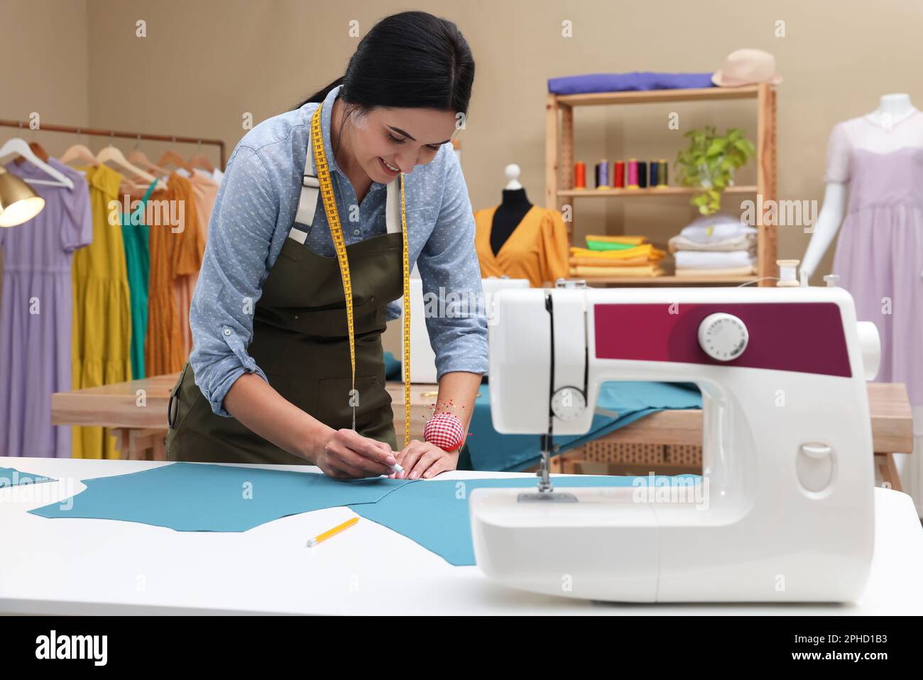 Dressmaker marking fabric with chalk in workshop Stock Photo - Alamy