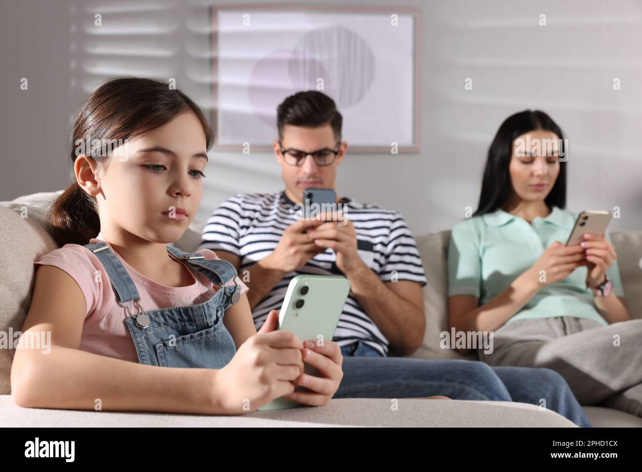 Internet addiction. Family with different gadgets on sofa at home Stock ...