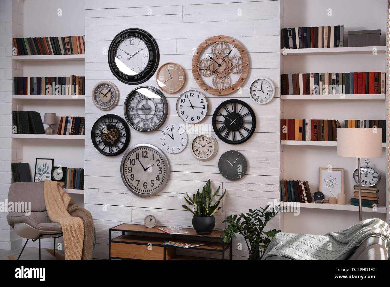 Stylish room interior with console table, comfortable furniture and ...