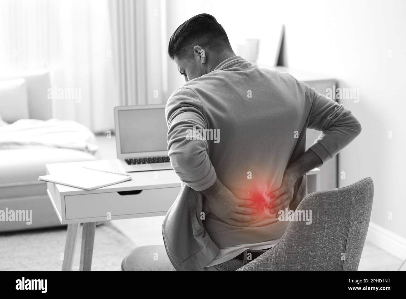Man suffering from back pain at workplace. Bad posture problem Stock ...