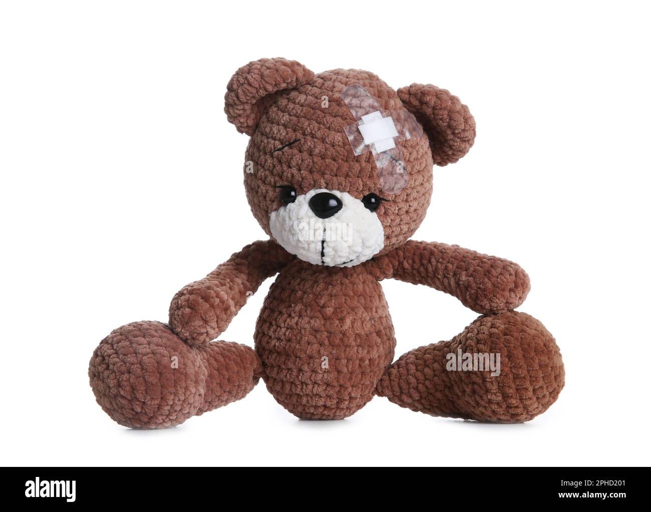 Cute toy bear with sticking plaster isolated on white. Children's ...