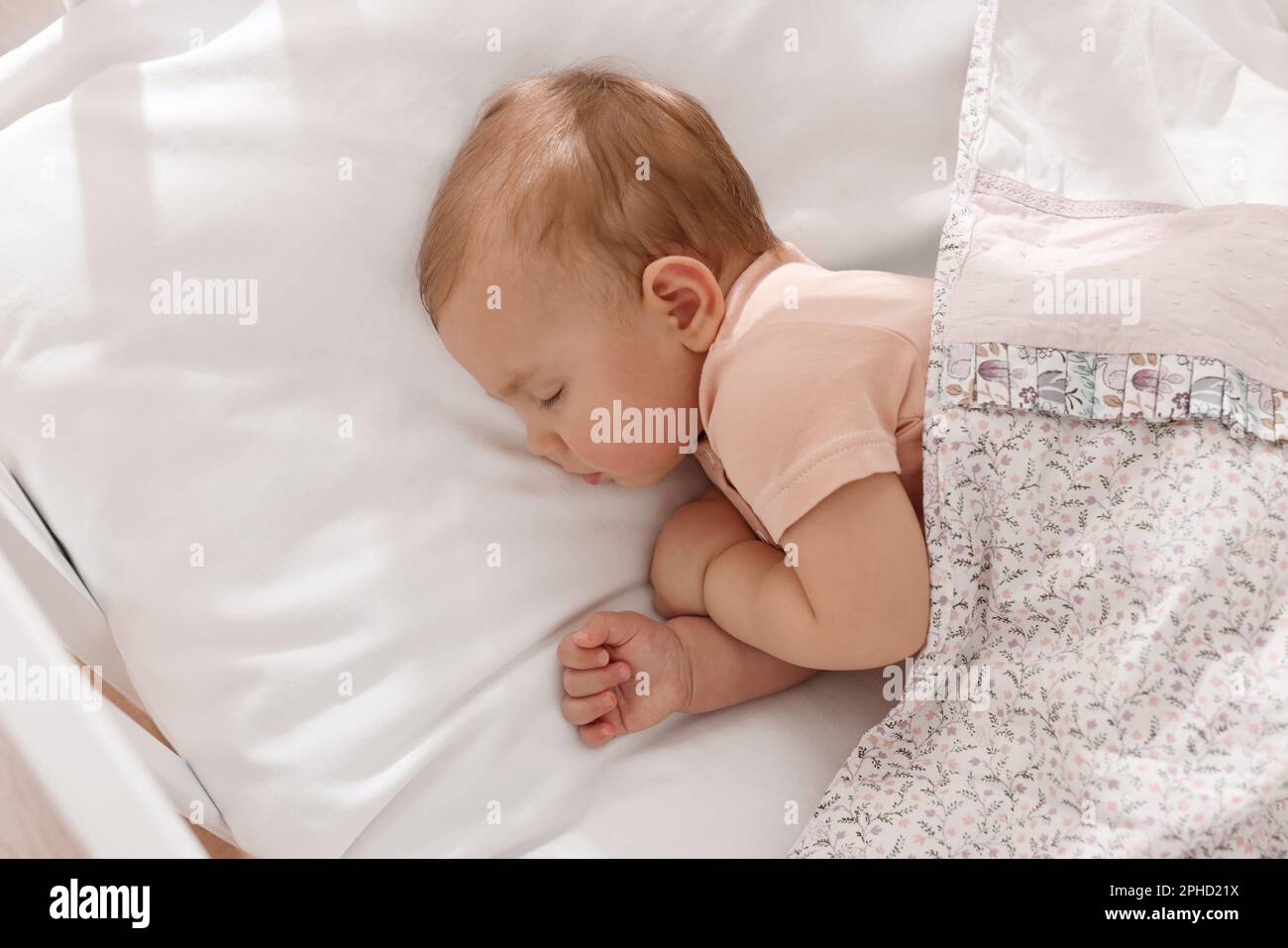 Cute little baby sleeping in soft crib, top view Stock Photo - Alamy
