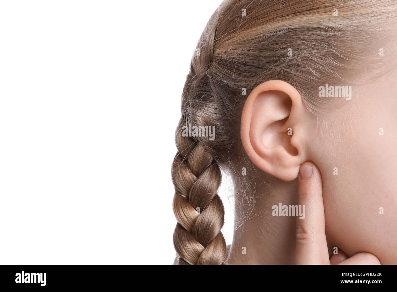 Cute little girl pointing at her ear on white background, closeup Stock ...