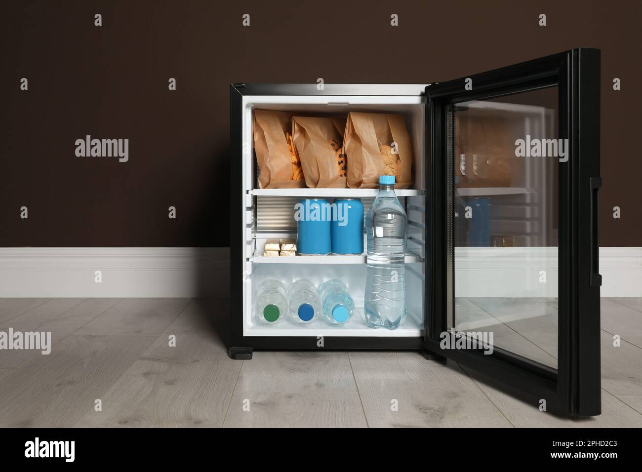 Mini bar filled with food and drinks near brown wall indoors Stock ...