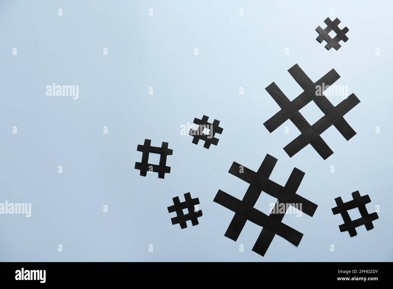 Paper hashtag symbols on light grey background, flat lay. Space for ...