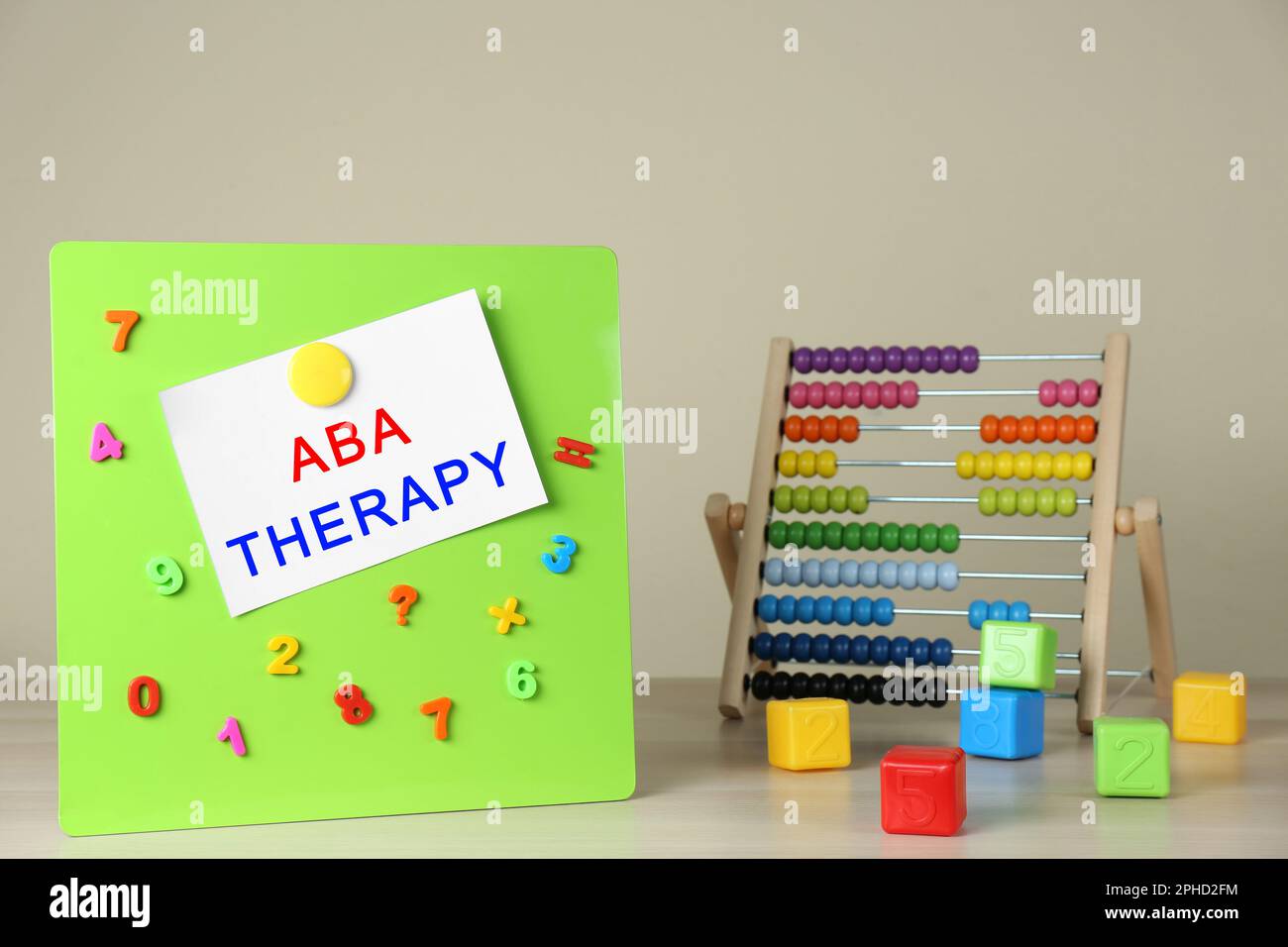 Magnetic board with phrase ABA Therapy, colorful numbers and abacus on ...