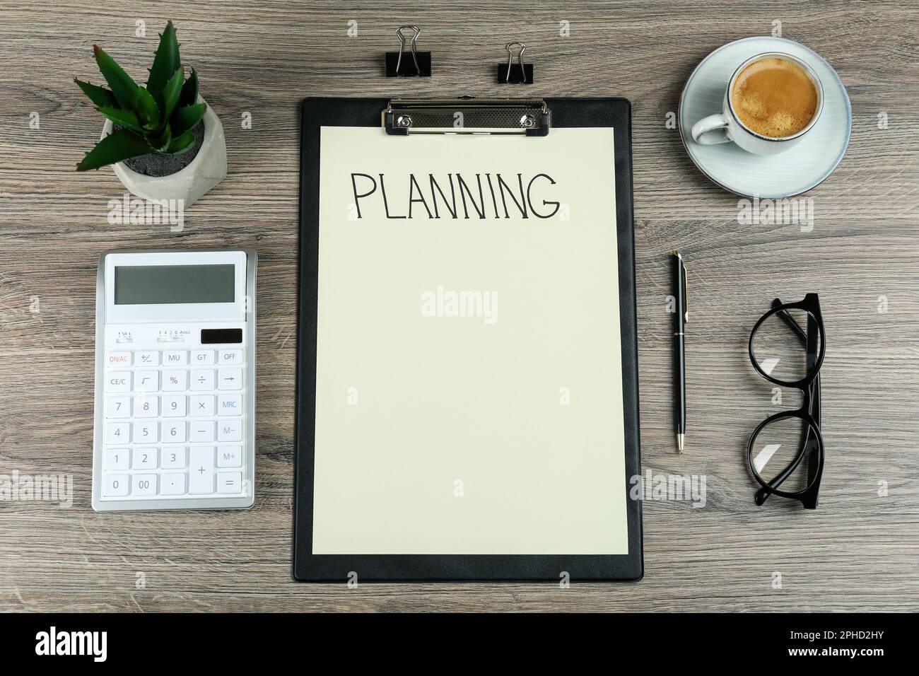 Flat lay composition of clipboard with word Planning, calculator ...