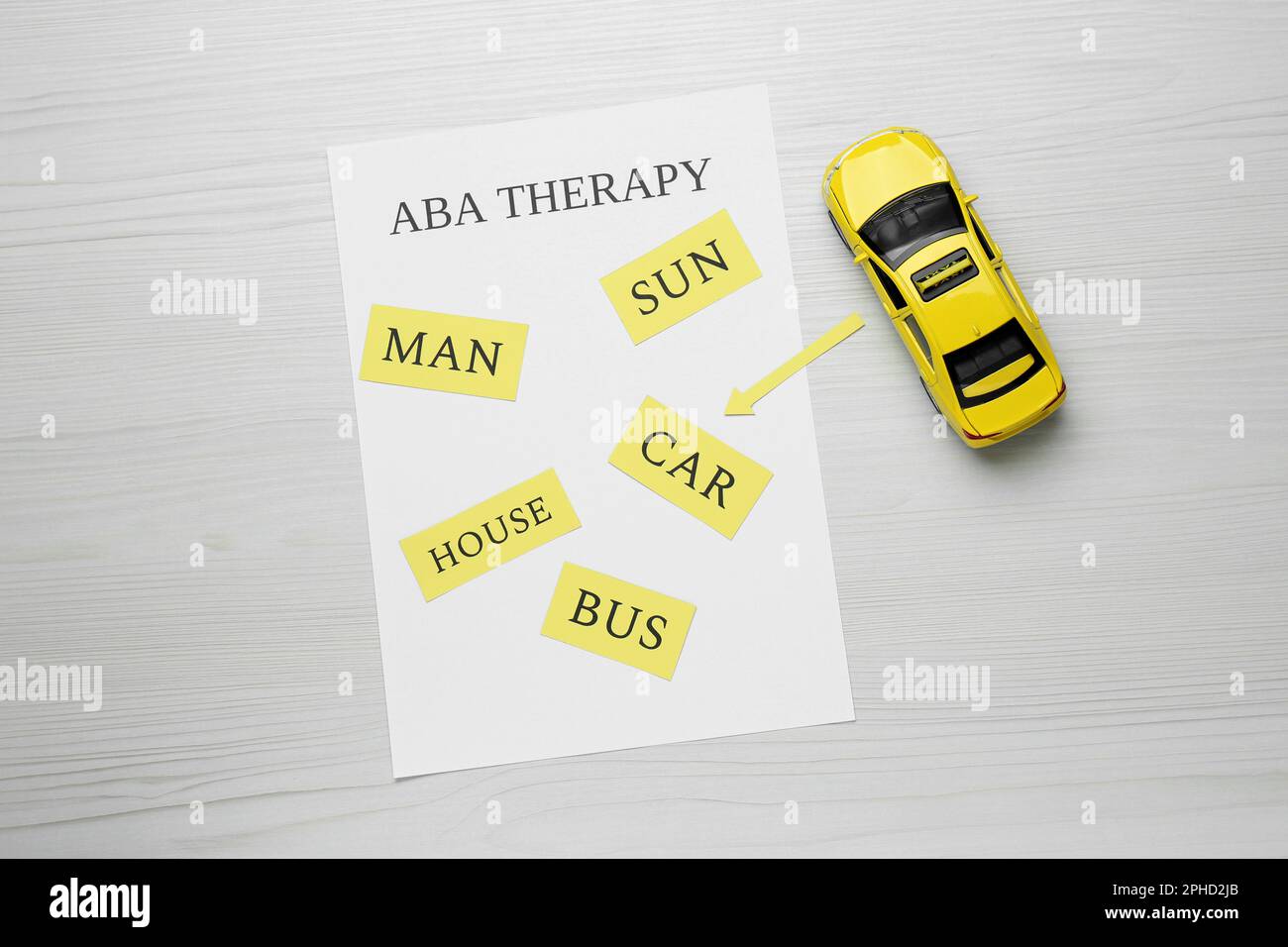Taxi car model and paper sheet with phrase ABA Therapy on white wooden ...