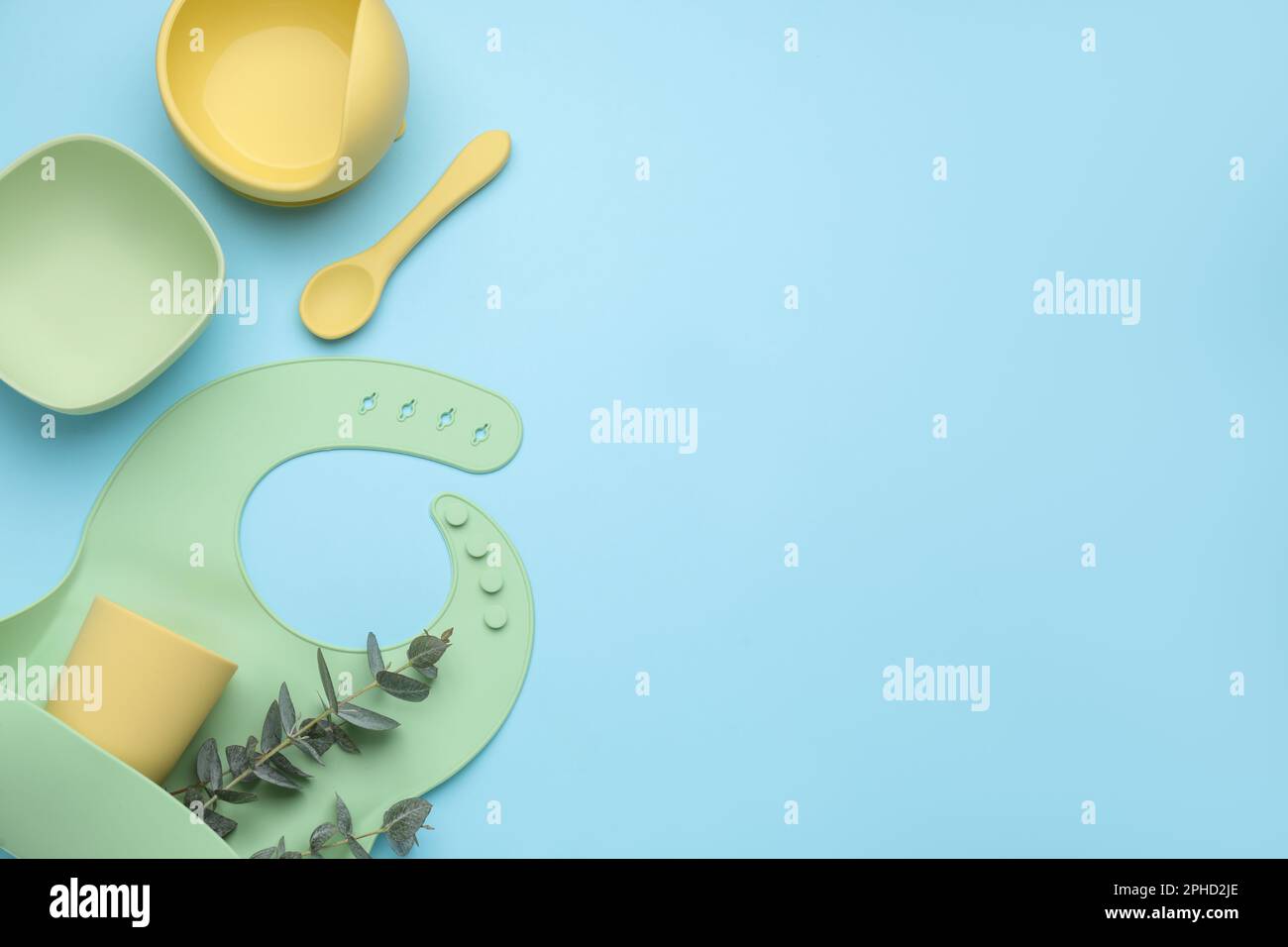 Flat lay composition with baby feeding accessories and bib on light ...