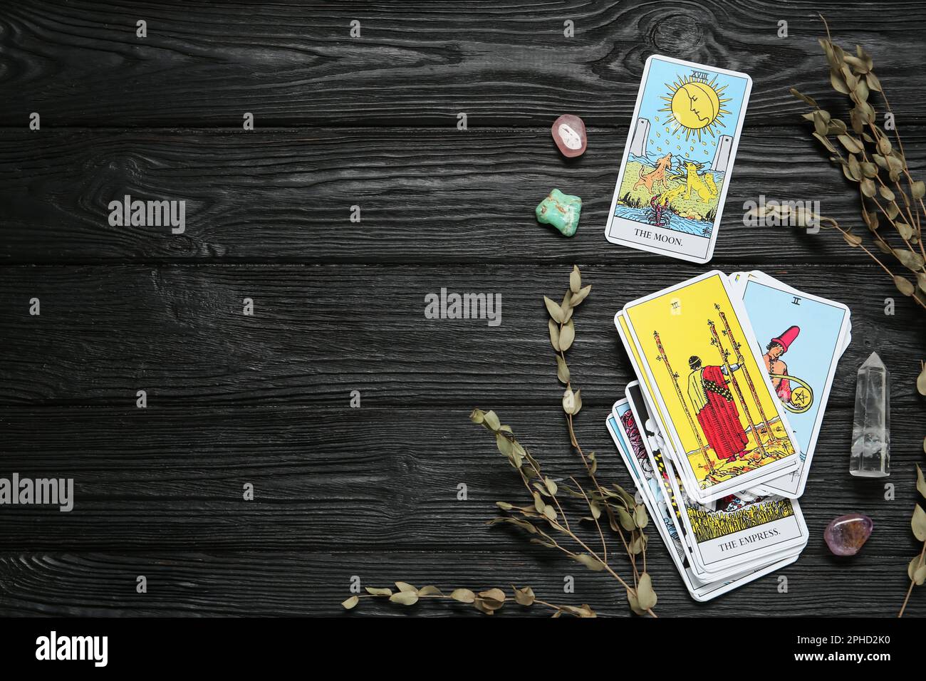 Flat lay composition with Moon and other tarot cards on black wooden ...