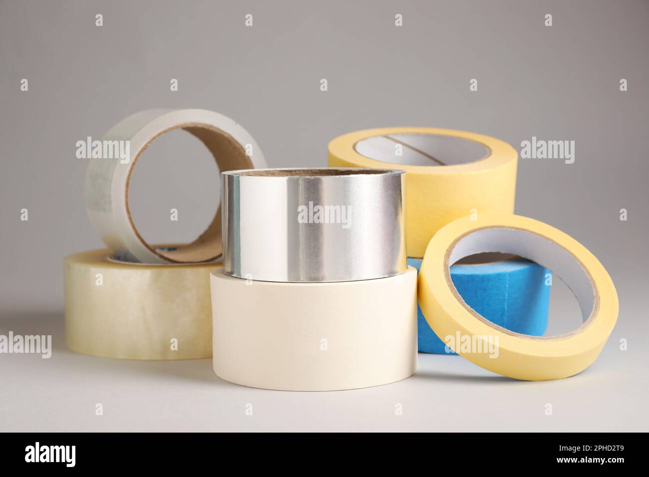 Many rolls of adhesive tape on light grey background Stock Photo - Alamy
