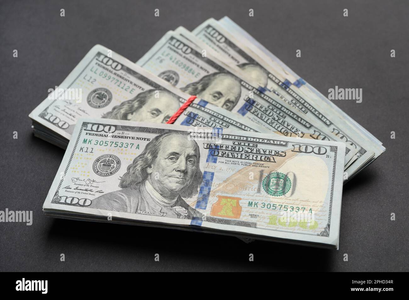 Many dollar banknotes on black background, closeup. American national ...