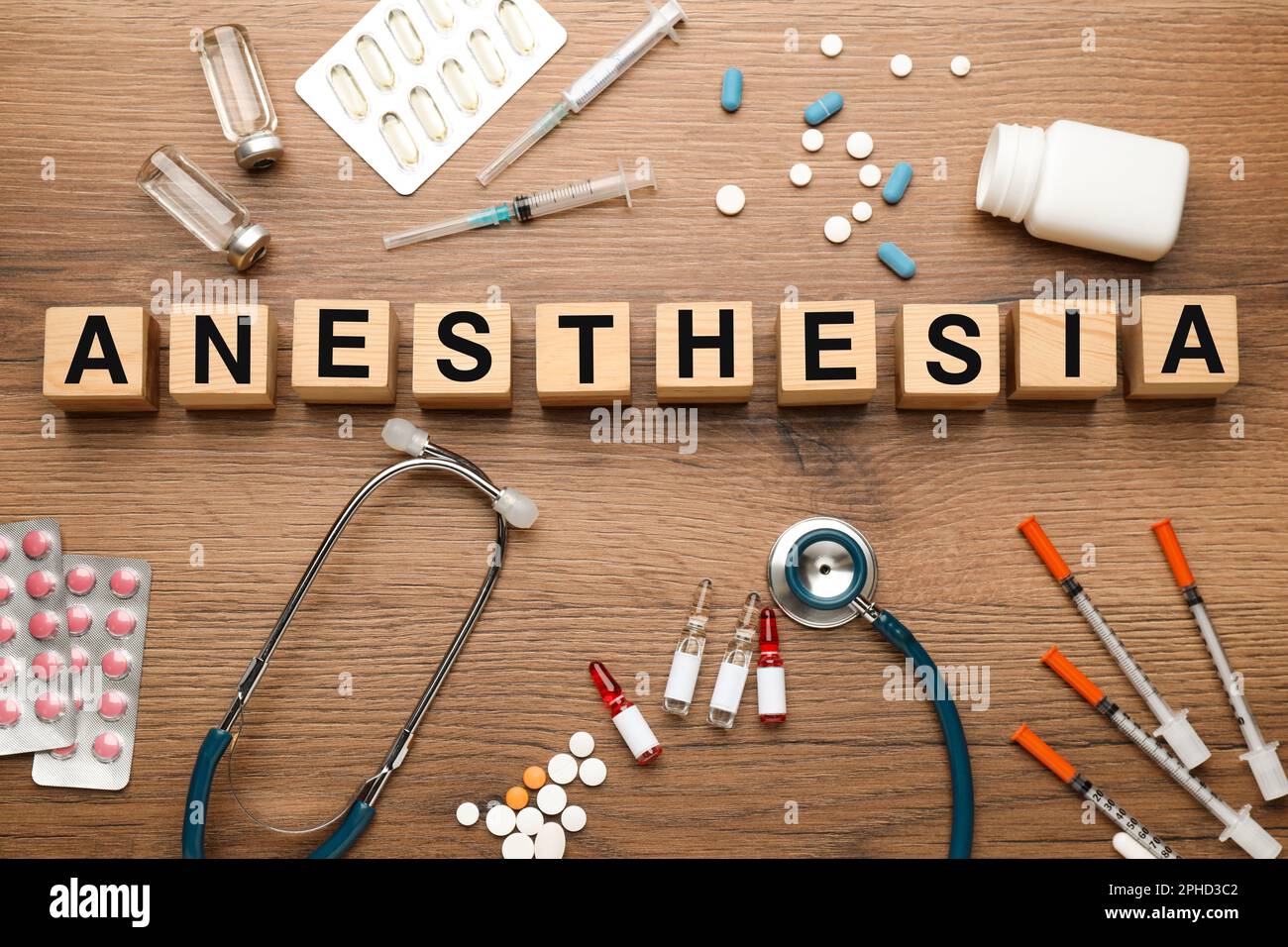 Word Anesthesia made of wooden cubes, stethoscope and drugs on table ...