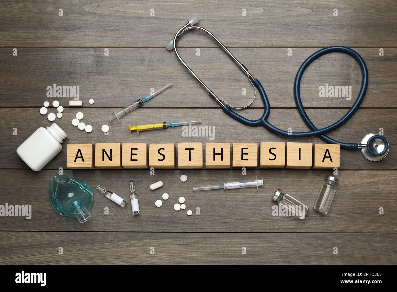 Flat lay composition with word Anesthesia made of cubes and drugs on ...