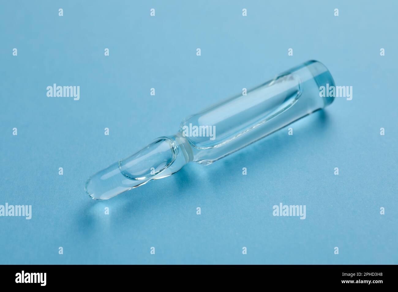 Medical ampoule with solution for injection on light blue background ...