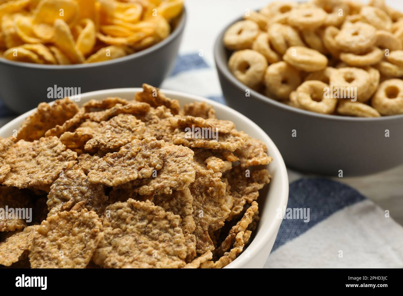 Different delicious breakfast cereals on kitchen towel, closeup Stock ...