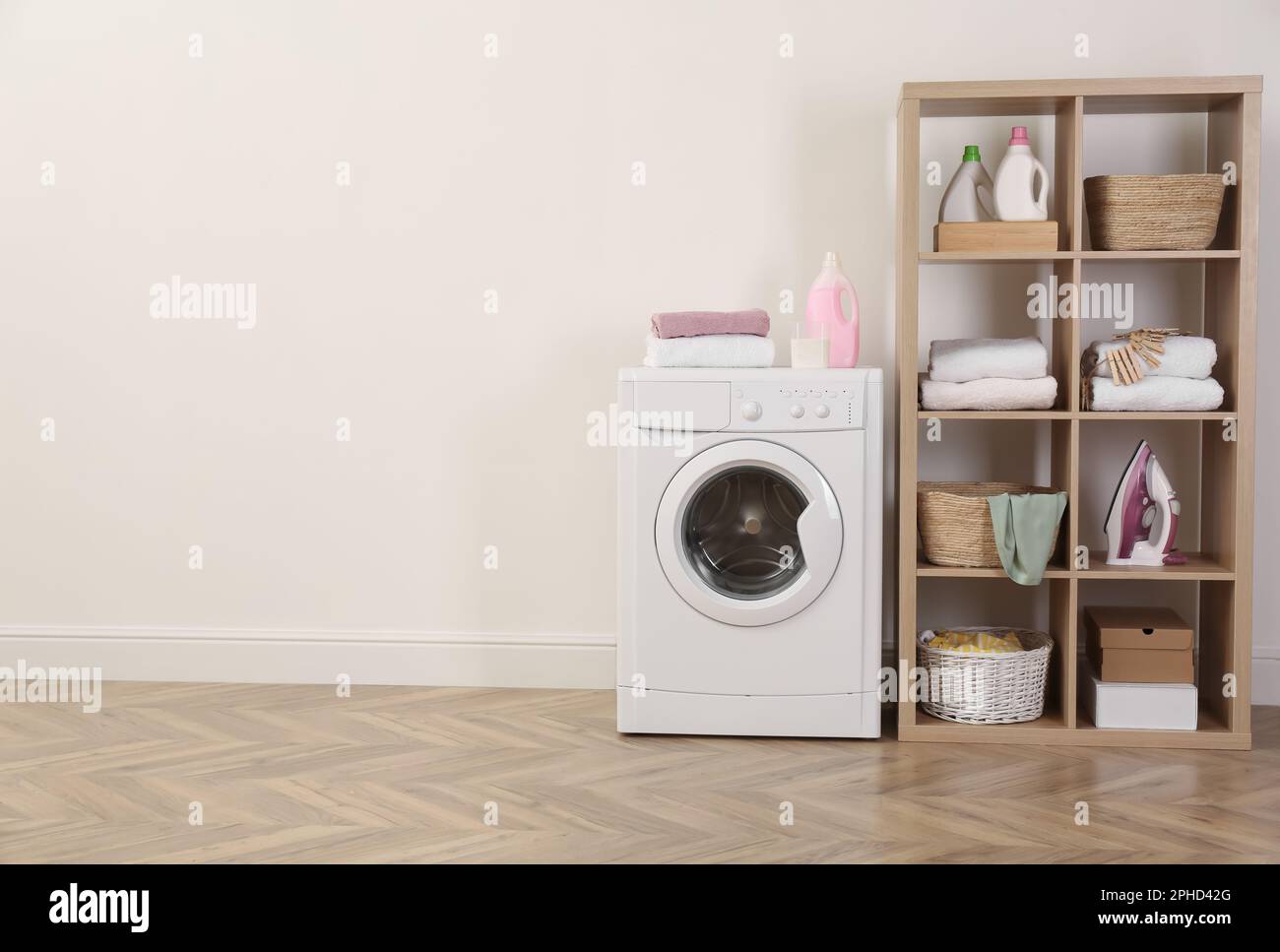 Laundry room interior with modern washing machine and shelving unit ...