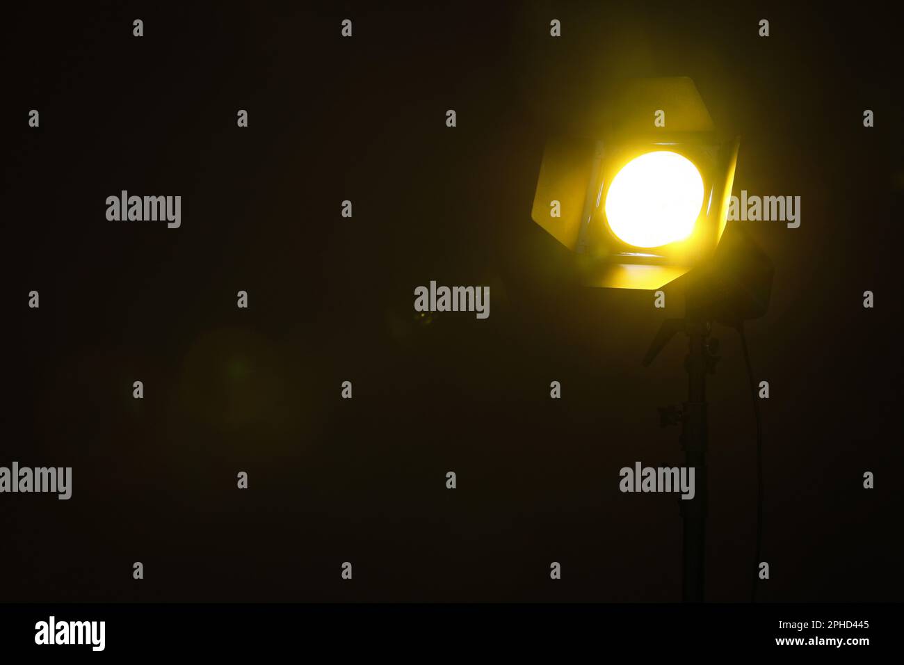Bright yellow spotlight in darkness, space for text Stock Photo - Alamy