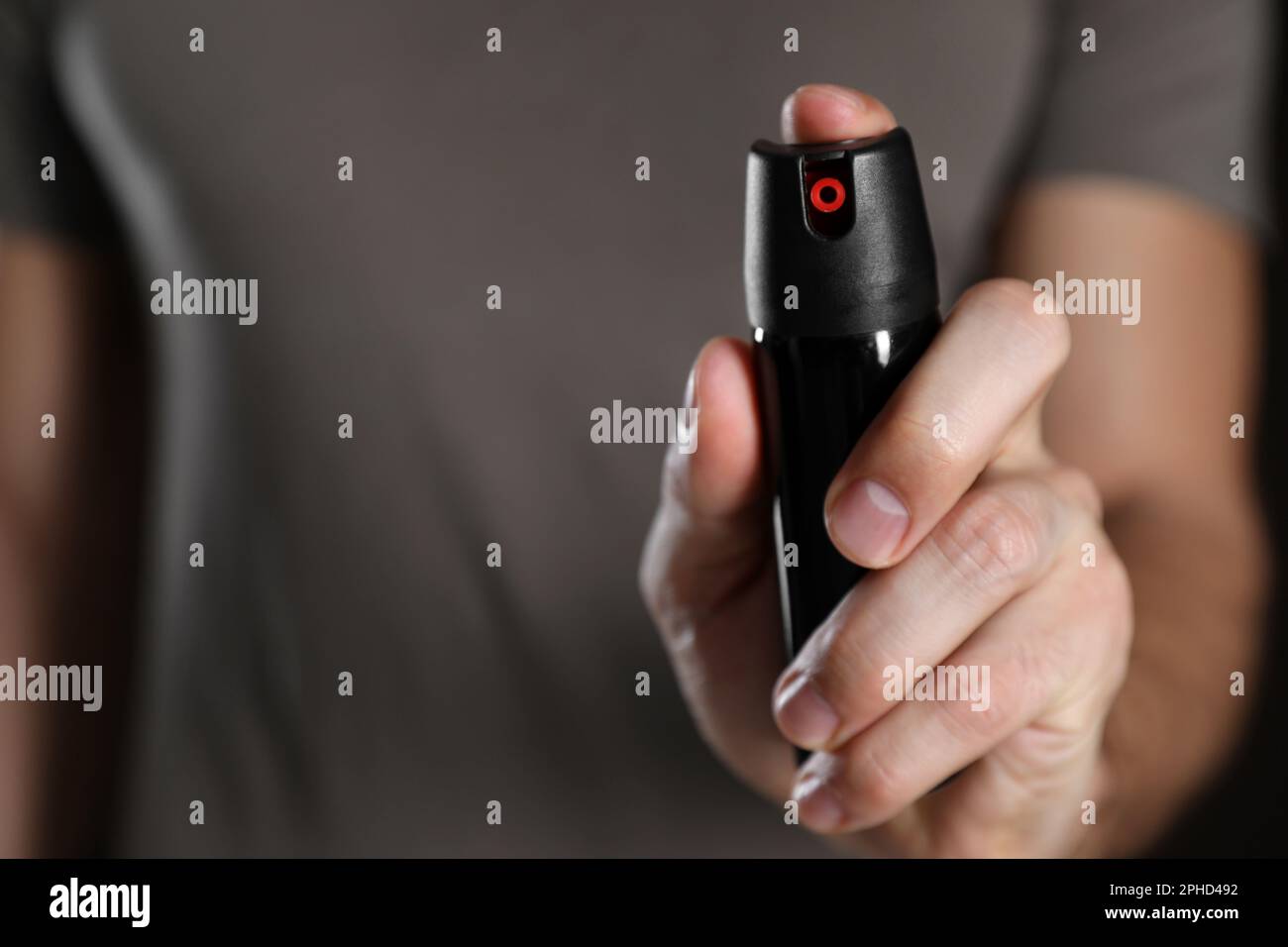 Man using pepper spray, closeup. Space for text Stock Photo - Alamy