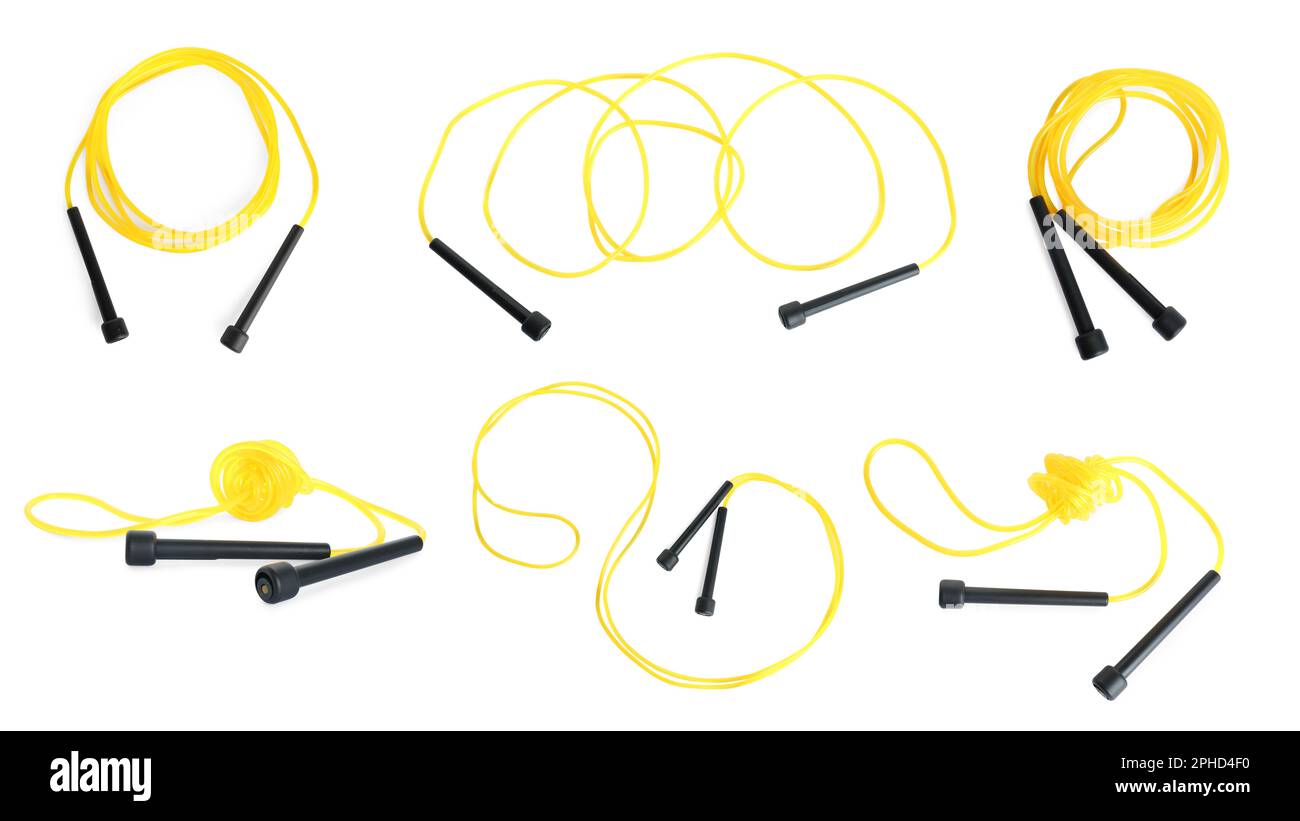 Set with yellow skipping ropes on white background Stock Photo - Alamy