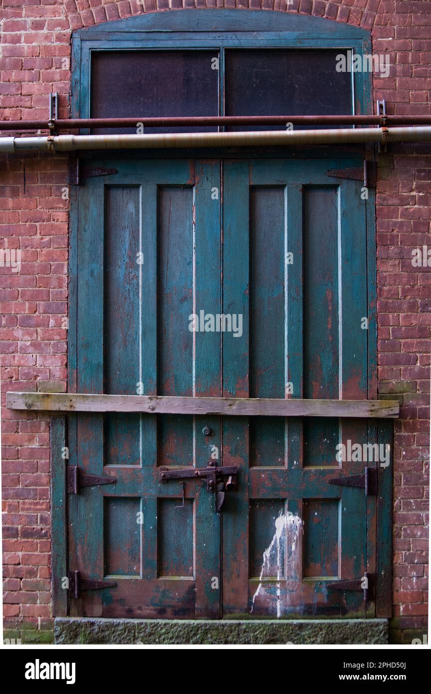Blocked door on abandoned factory building Stock Photo - Alamy