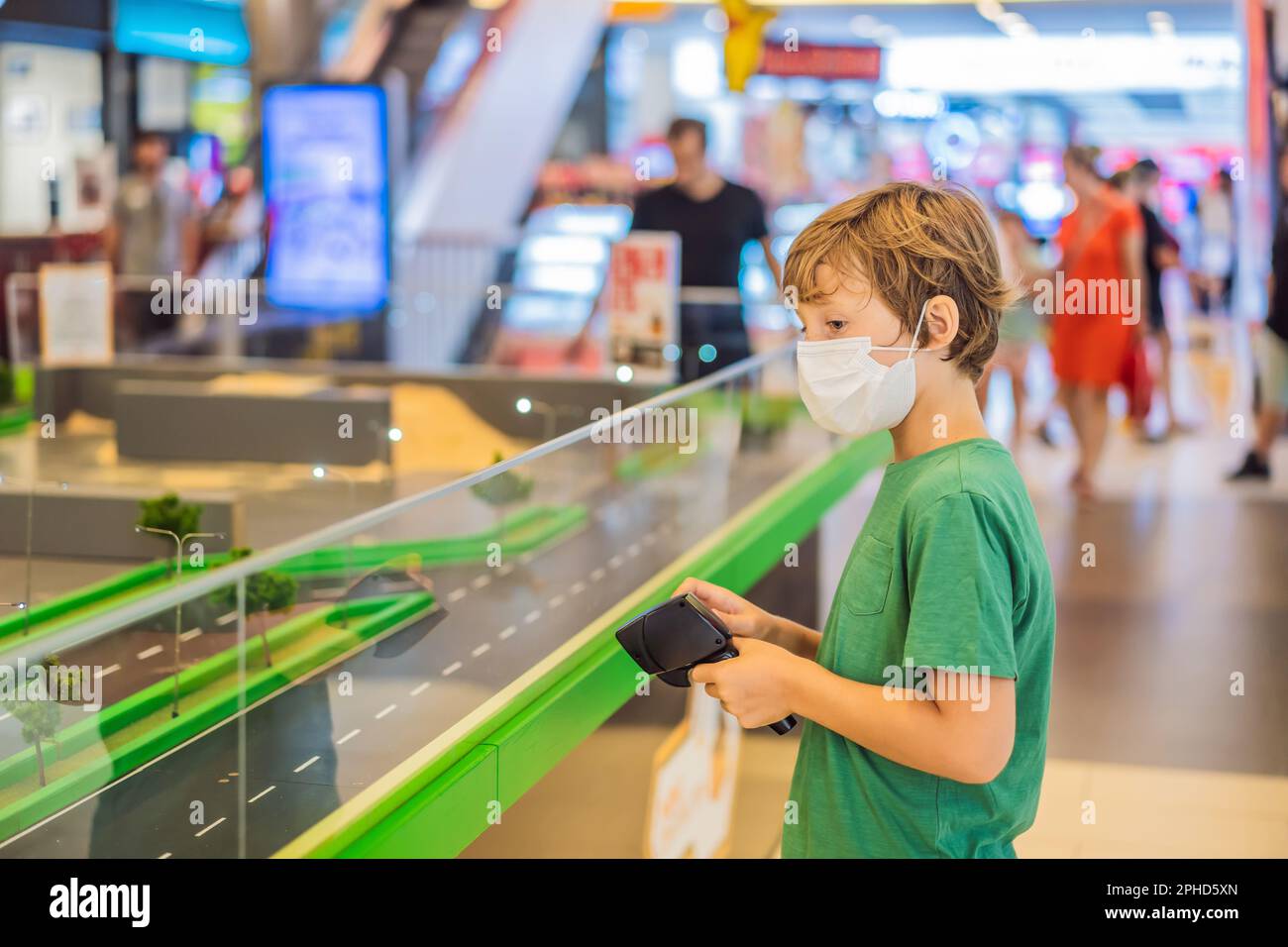 Adorable cute little child playing with toy on remote control, in the ...