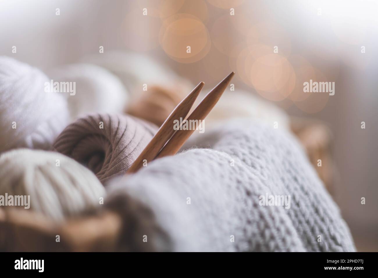 Cozy homely atmosphere. Female hobby knitting. Yarn in neutral shades ...
