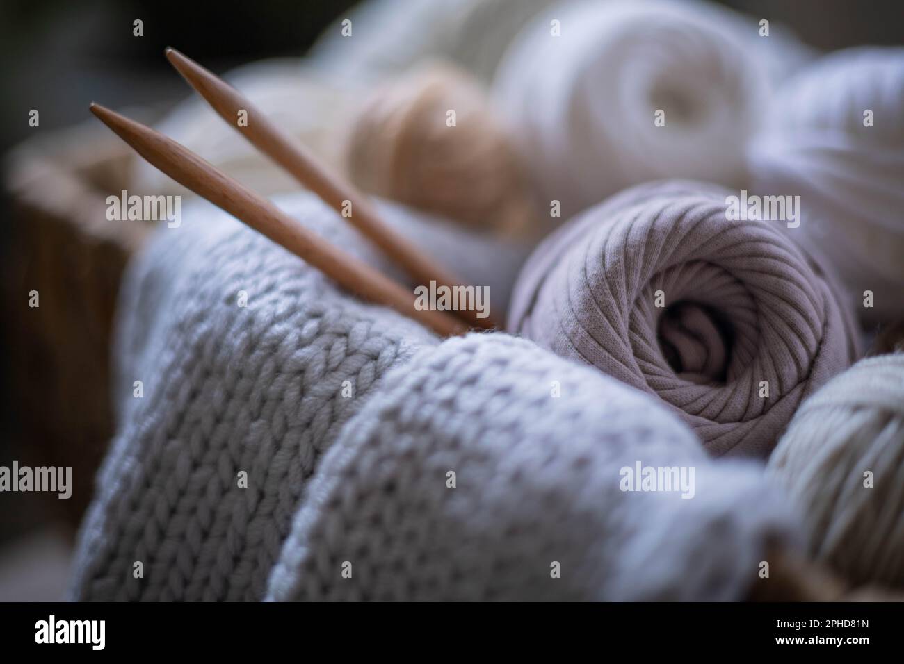 Cozy homely atmosphere. Female hobby knitting. Yarn in neutral shades ...