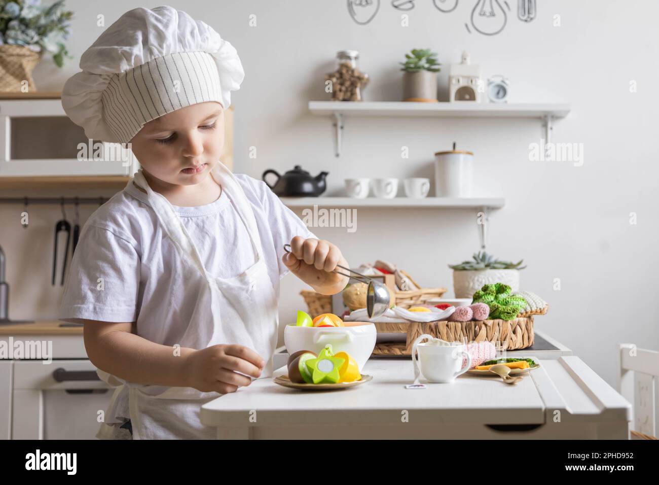 Cute baby boy chef uniform cooking playthings vegetable salad at ...