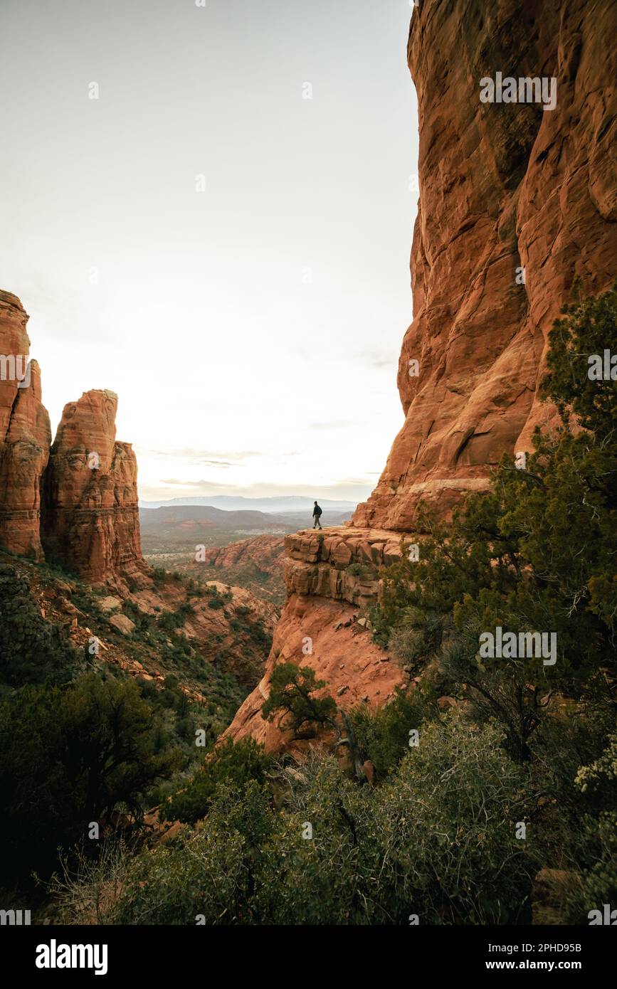 Wide angle view of woman watching sunset in Sedona Arizona from ...