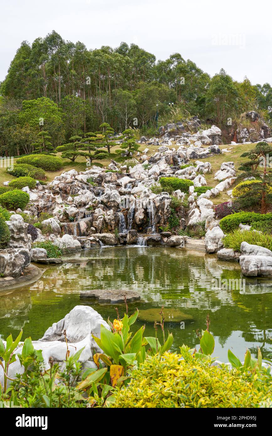 Rockery and pond in a beautiful garden Stock Photo - Alamy