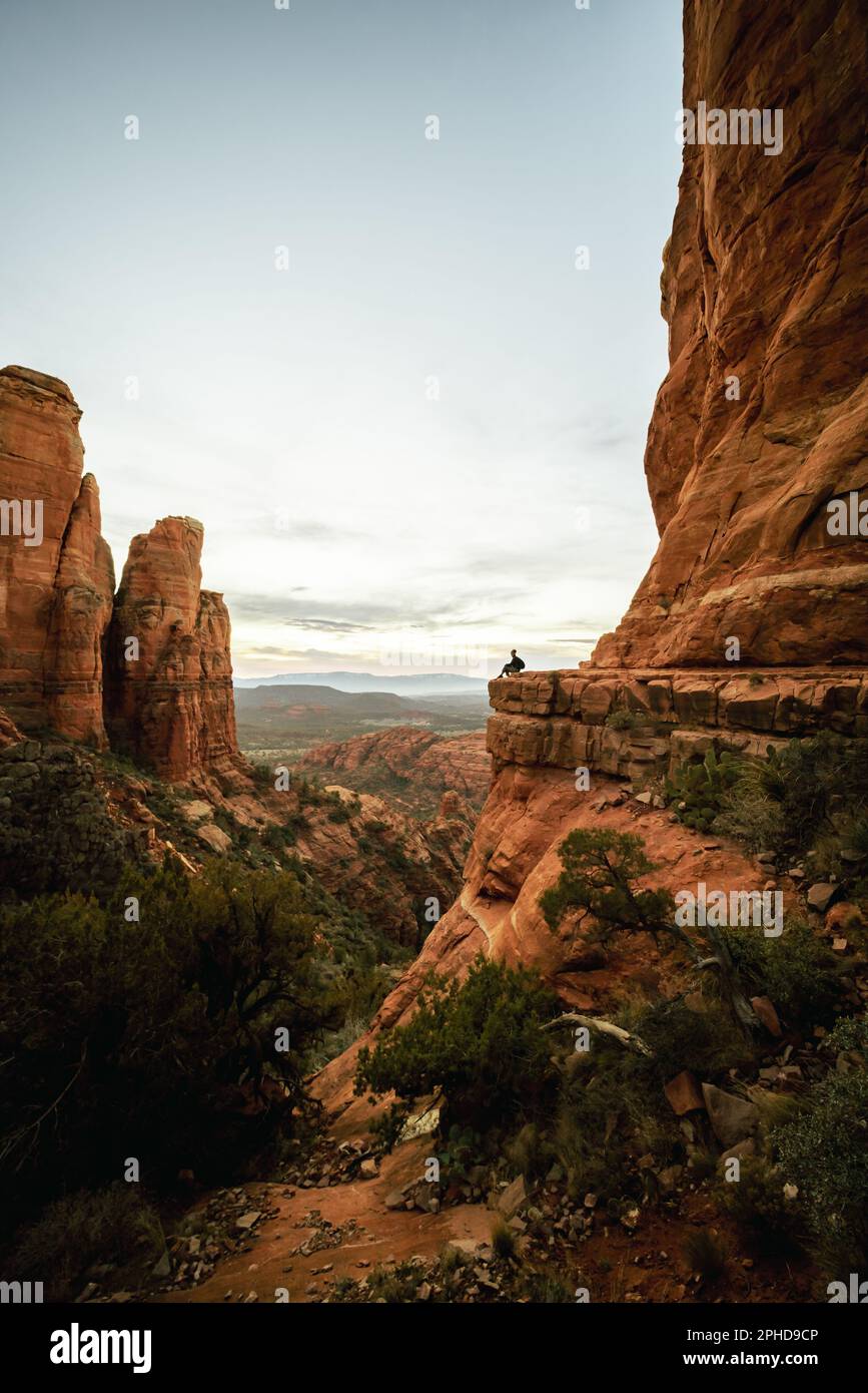 Wide angle view of woman sitting at sunset in Sedona Arizona from ...