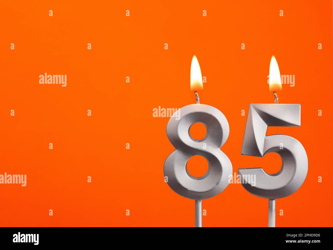 Number 85 - Silver Anniversary candle on orange background Stock Photo ...
