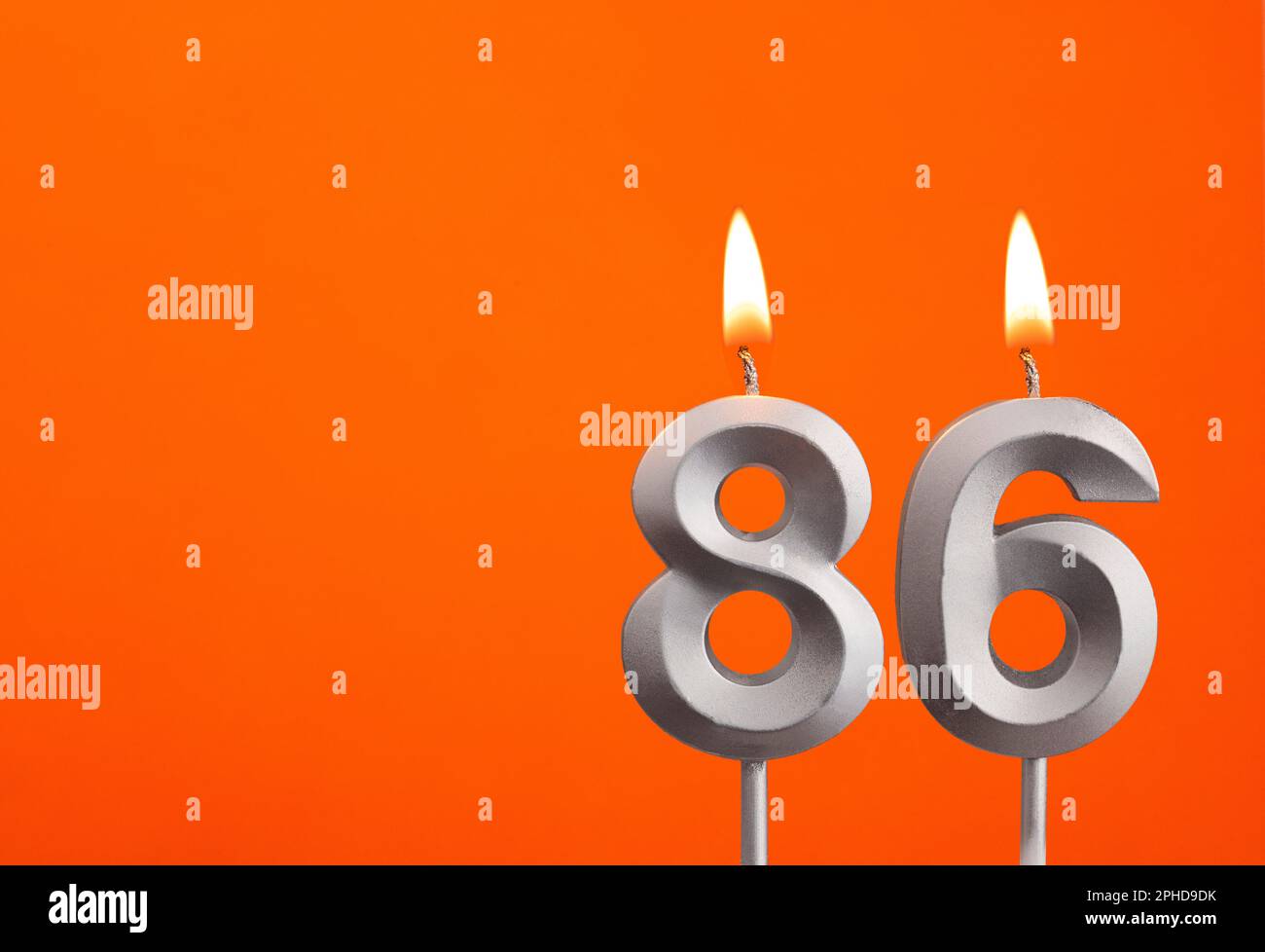 Candle number 86 - Birthday in orange background Stock Photo - Alamy