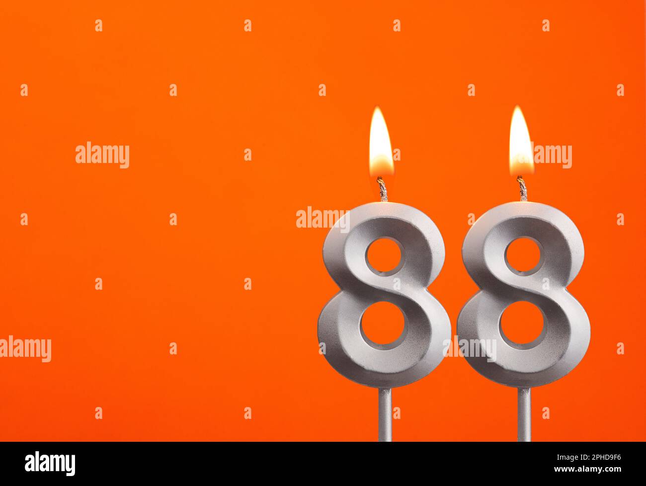 Candle number 88 - Birthday in orange background Stock Photo - Alamy