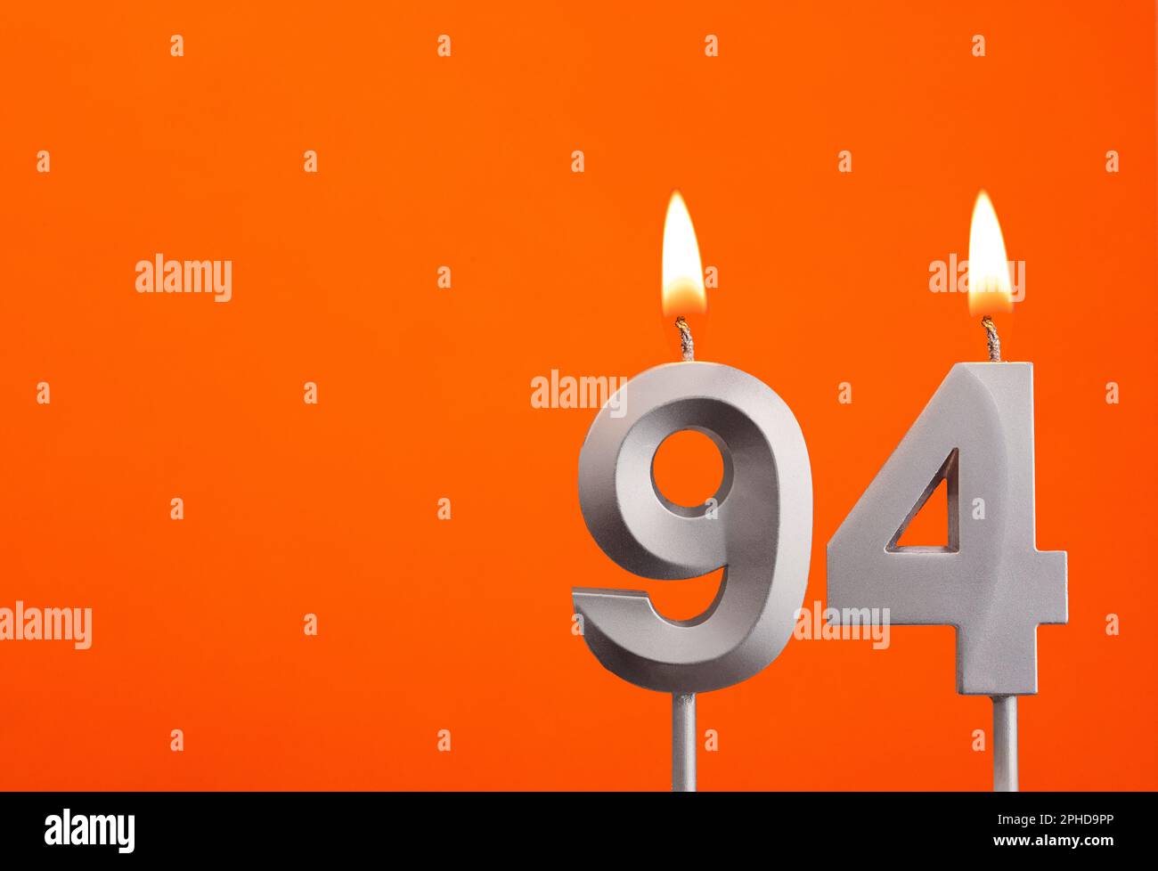 Candle number 94 - Birthday in orange background Stock Photo - Alamy
