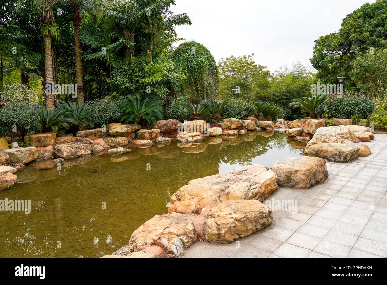 wide stone pond in park garden Stock Photo - Alamy