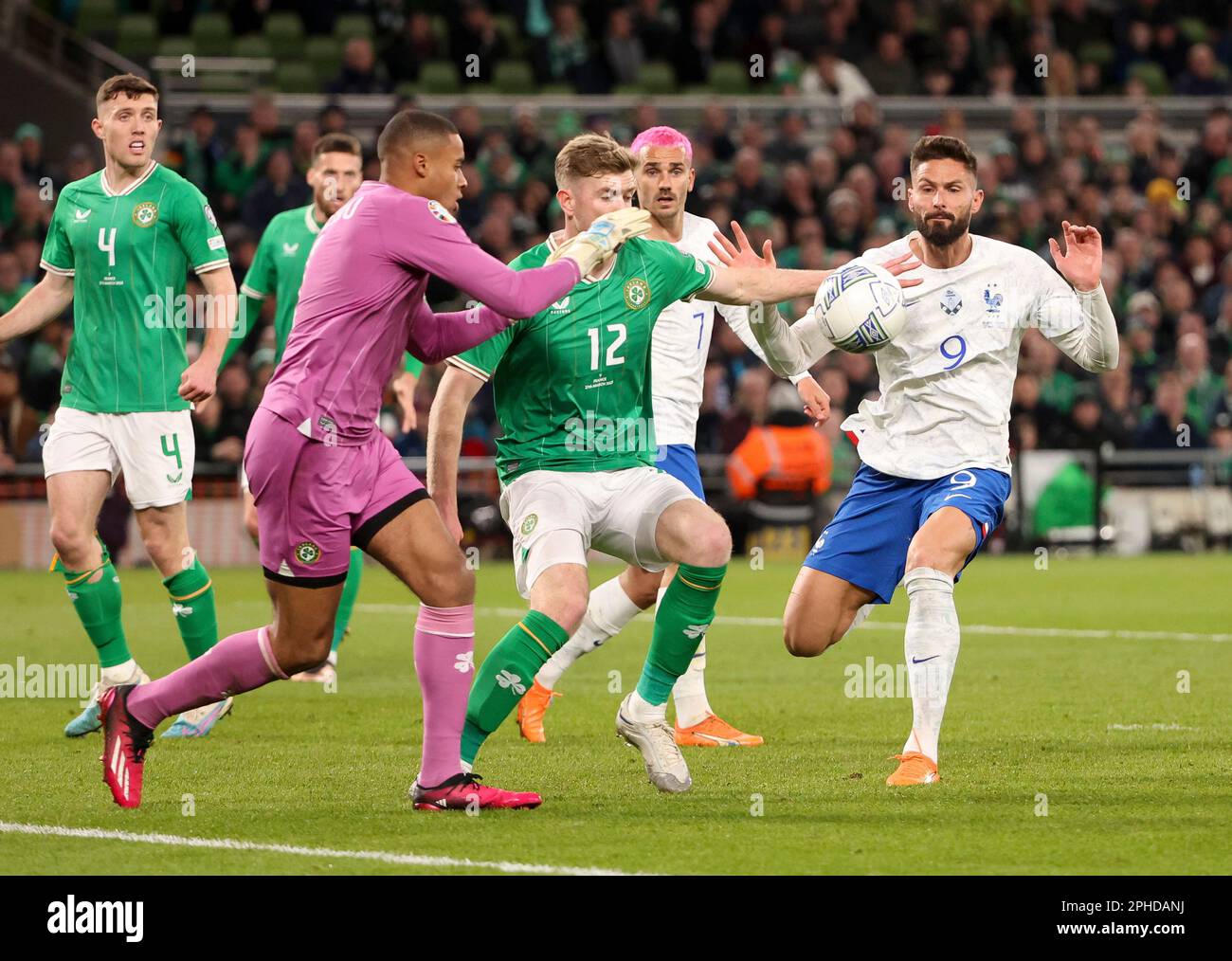 Dublin, Ireland. 27th Mar, 2023. Olivier Giroud of France (right), left ...