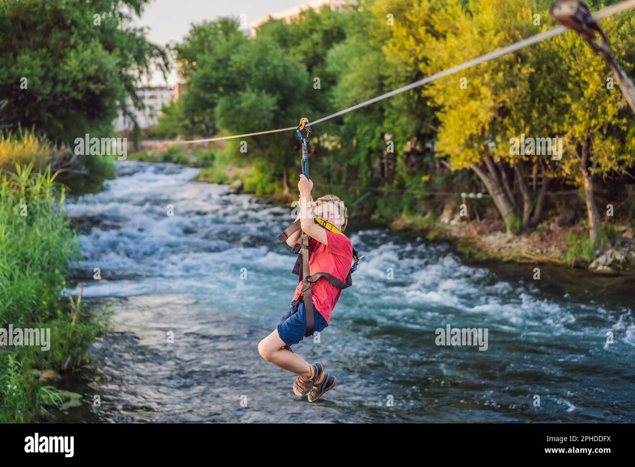Kid Zipline, Zipline Over the River. Kid Adventure Stock Photo - Alamy