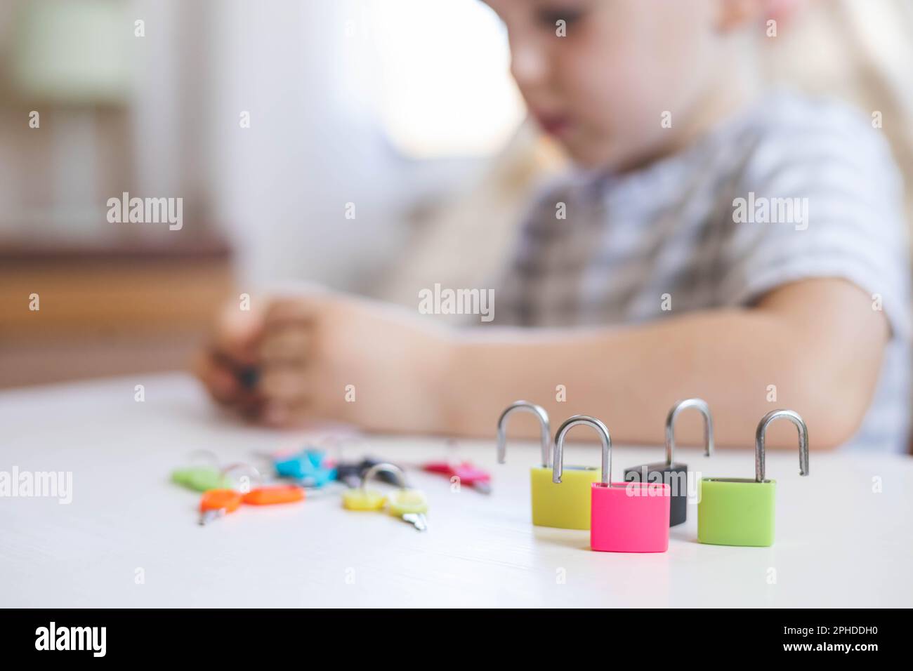 The child works with Montessori material with colored locks. Picks up ...