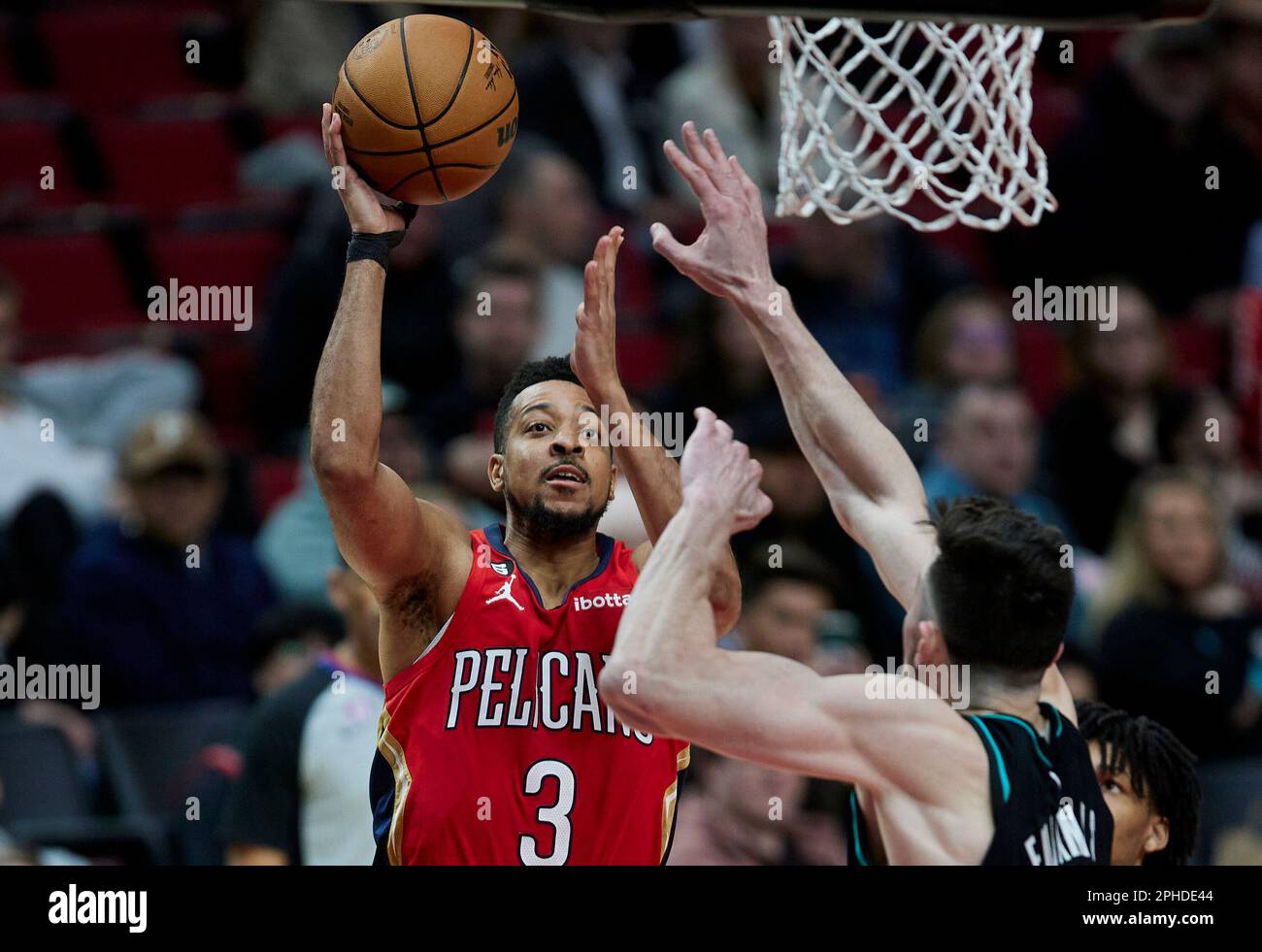 New Orleans Pelicans guard CJ McCollum, left, shoots over Portland ...