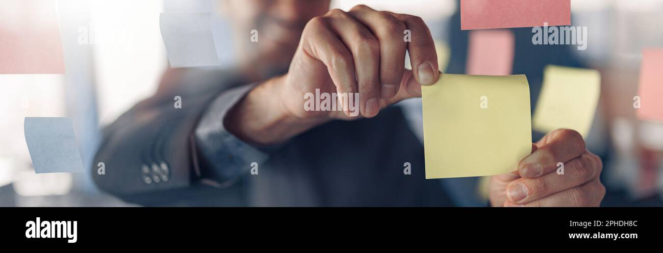 Businessman hand's is sticking sticky notes on motivation board in ...