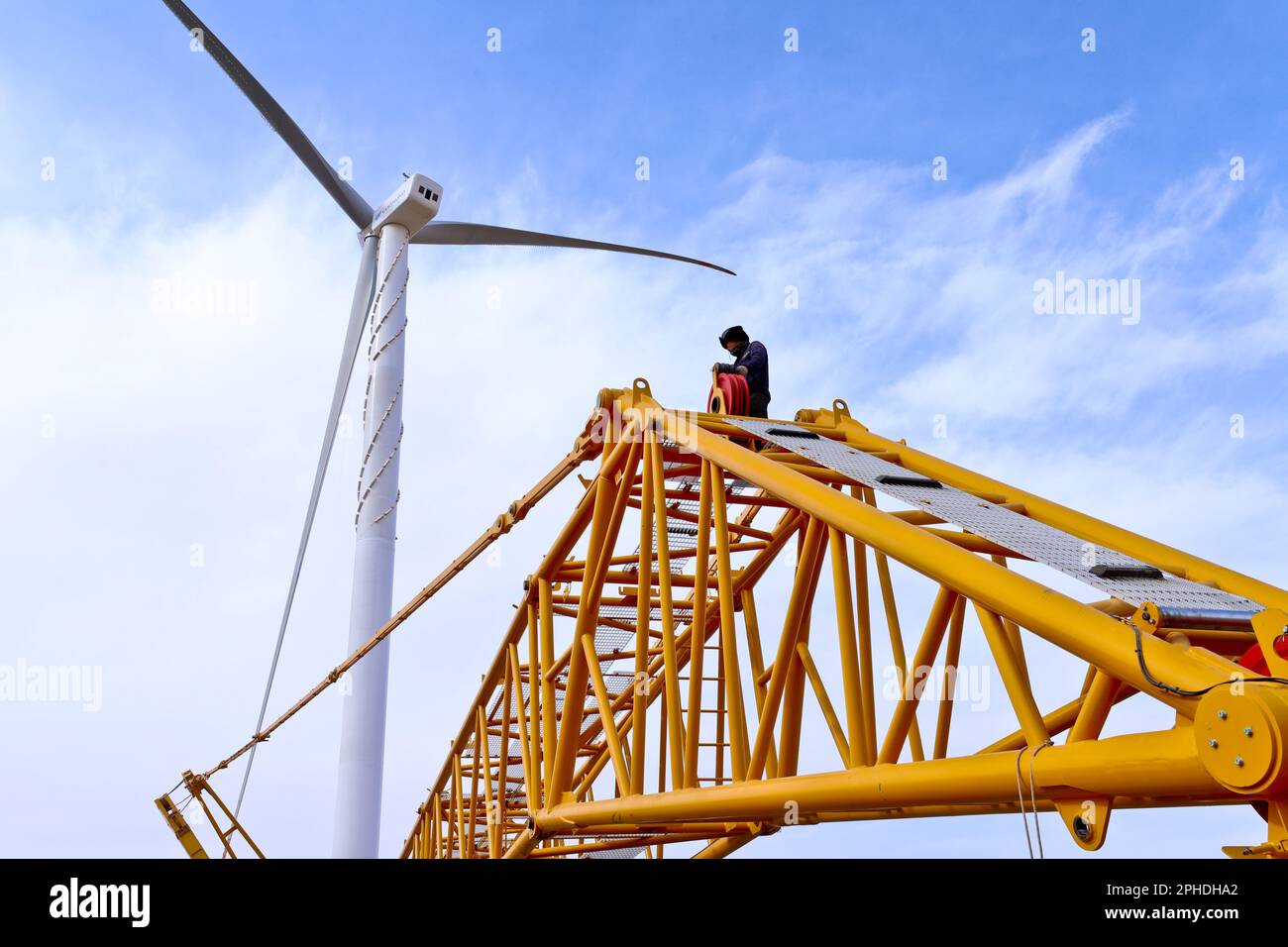 ZHANGYE, CHINA - MARCH 27, 2023 - Builders disassemble large hangers at the construction site of ...