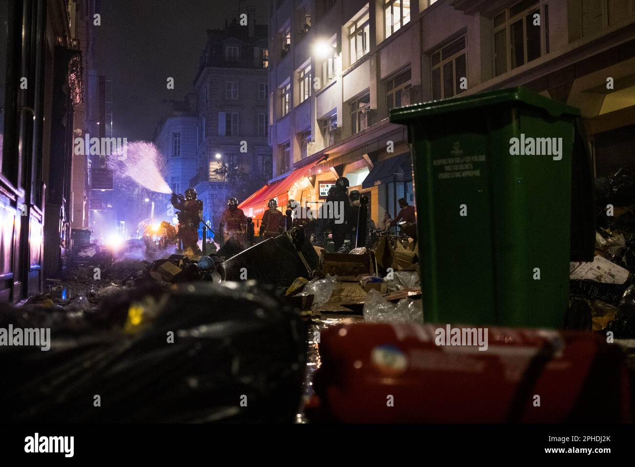Paris, France. 23rd Mar, 2023. A firefighter tries to extinguish bags ...