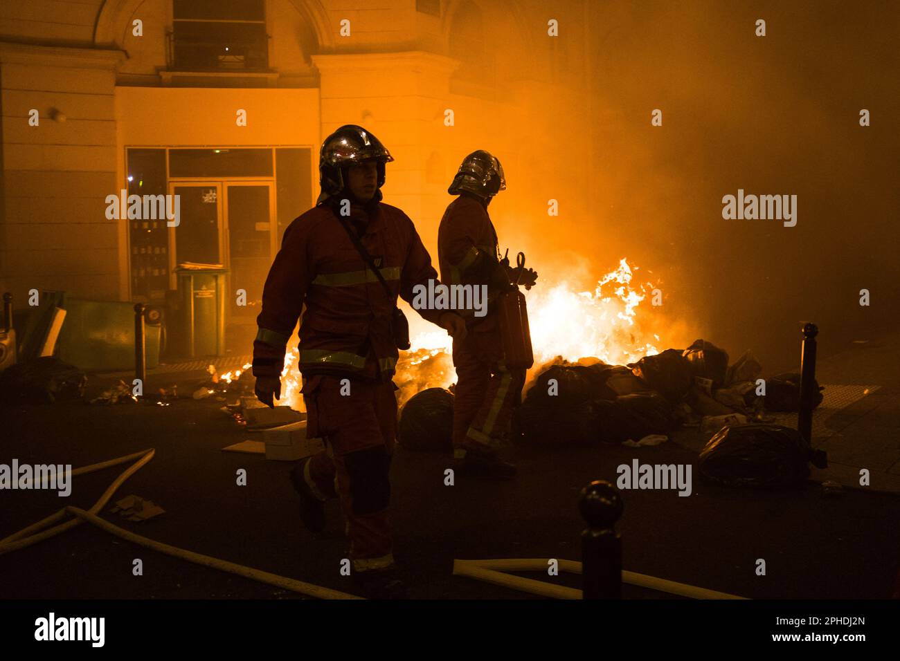 Paris, France. 23rd Mar, 2023. A firefighter tries to extinguish bags ...
